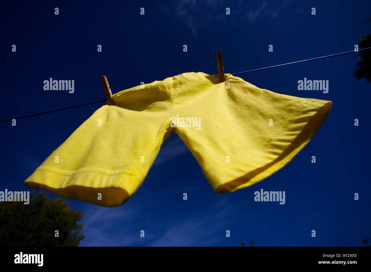 Yellow shorts on a washing line Stock Photo - Alamy