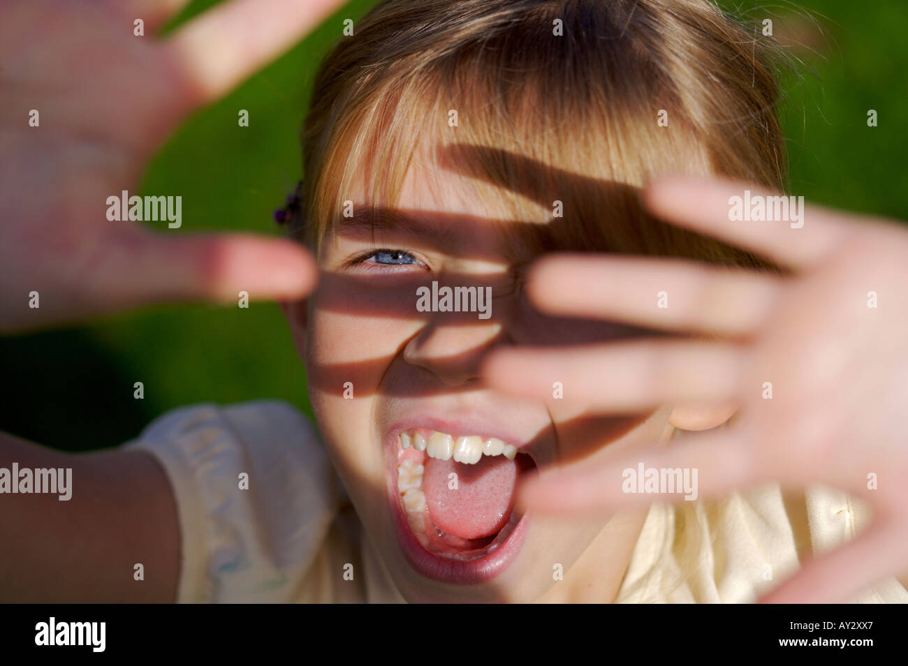 Young girl screaming with hands in front of her face Stock Photo - Alamy