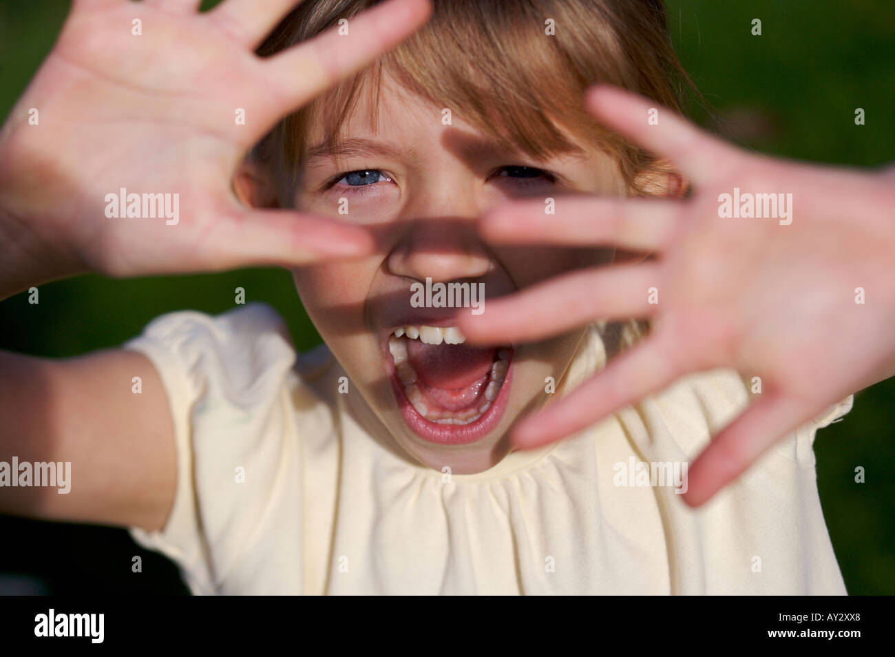 Young girl screaming with hands in front of her face Stock Photo - Alamy