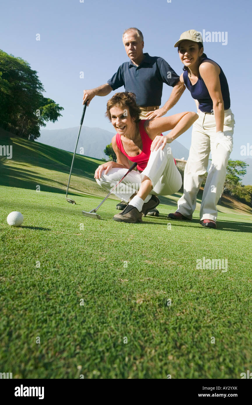 Multi-ethnic friends playing golf Stock Photo - Alamy
