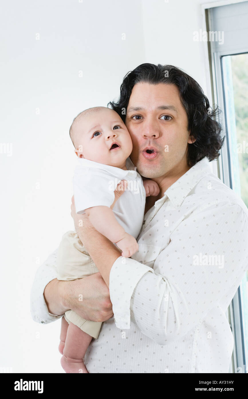 Asian father hugging baby Stock Photo - Alamy
