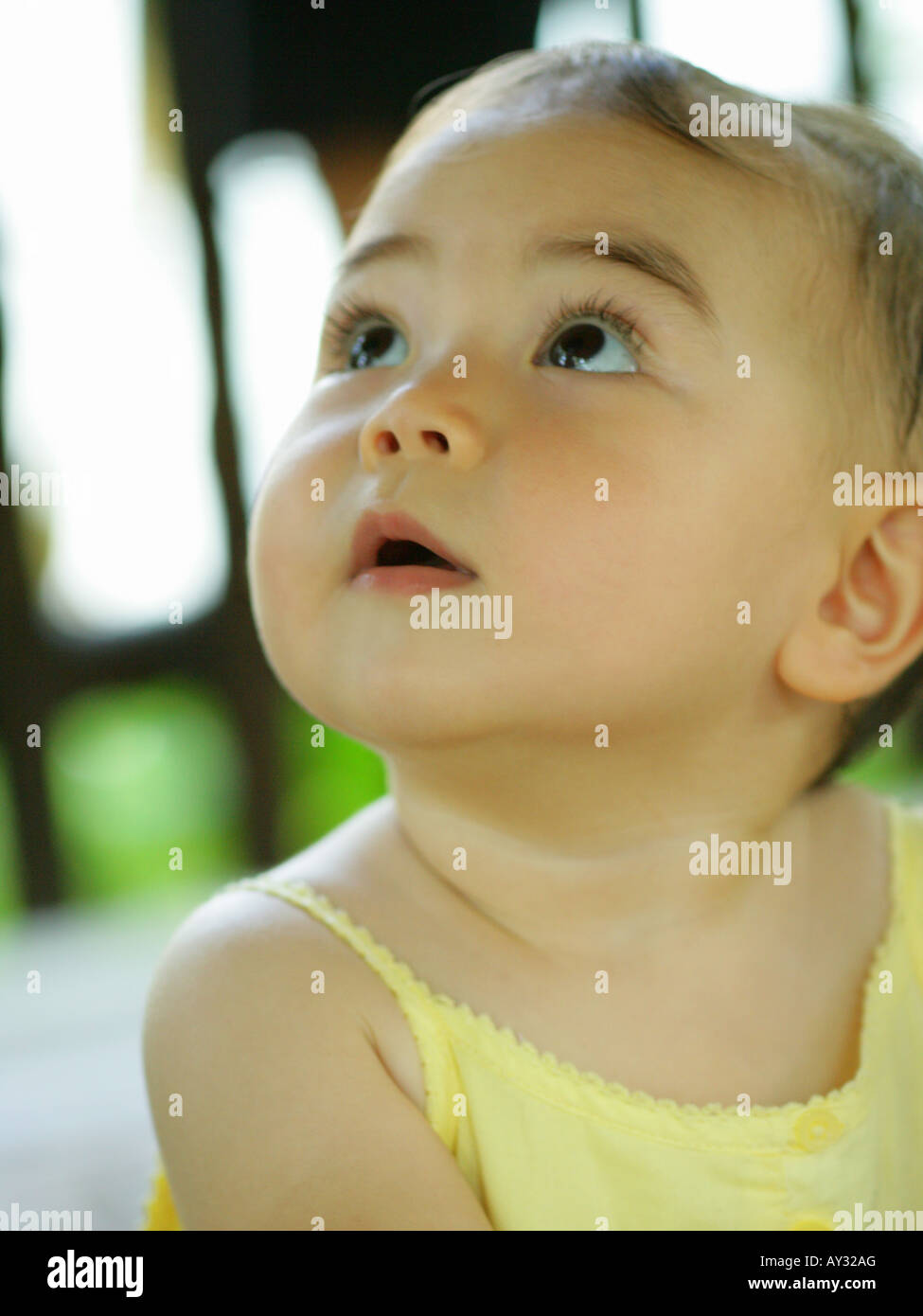 Close-up of a baby girl looking up Stock Photo - Alamy