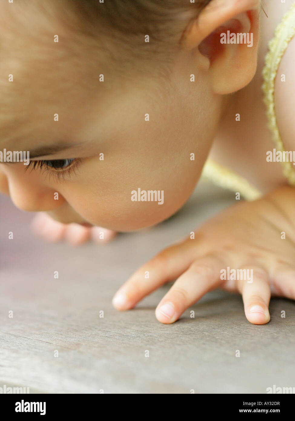 Close-up of a baby girl looking down Stock Photo - Alamy
