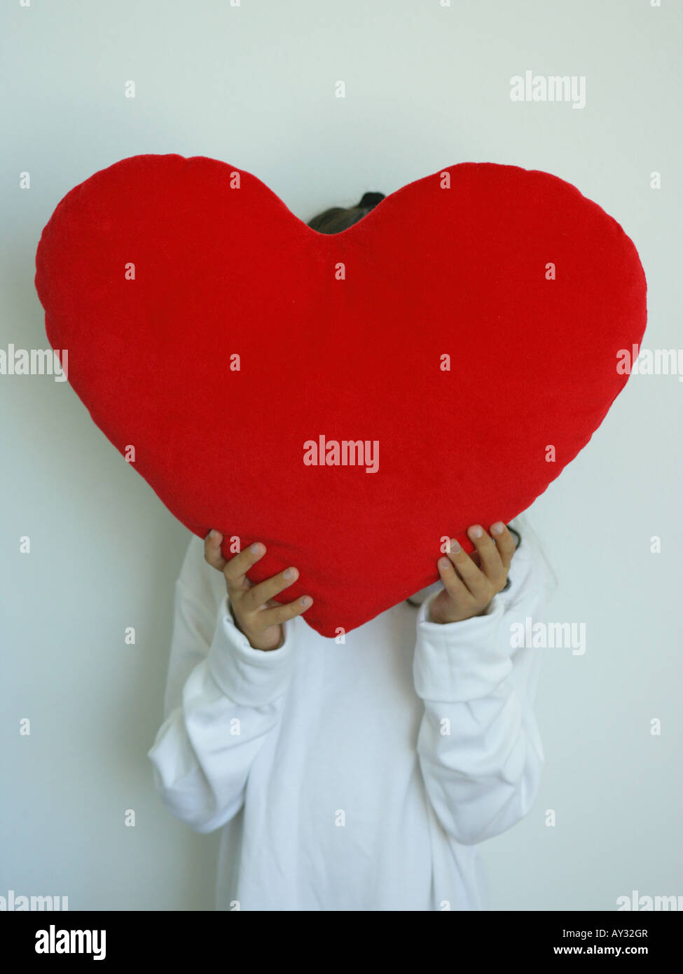 Close-up of a person covering her face with a valentine heart Stock ...