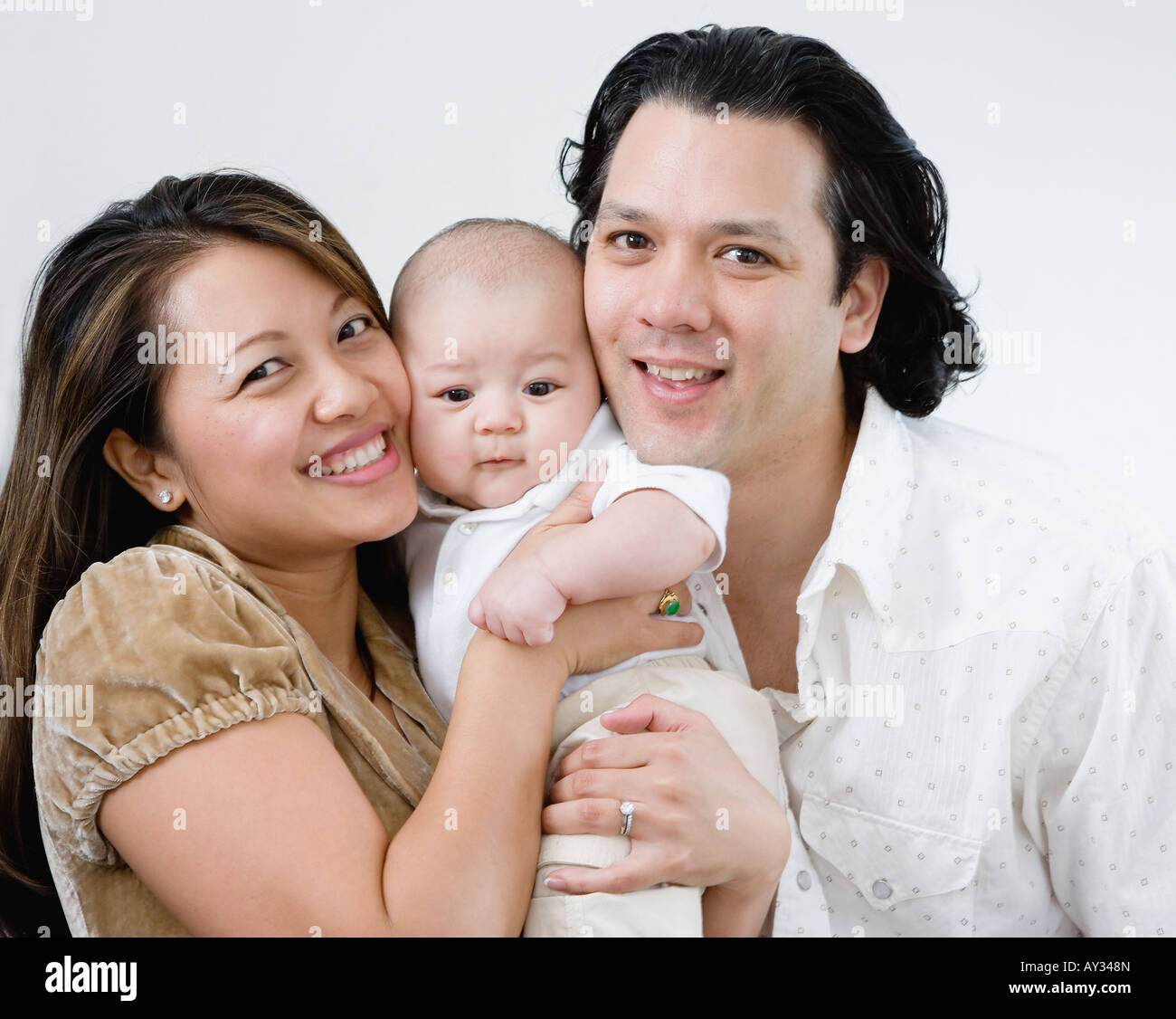 Asian parents hugging baby Stock Photo - Alamy