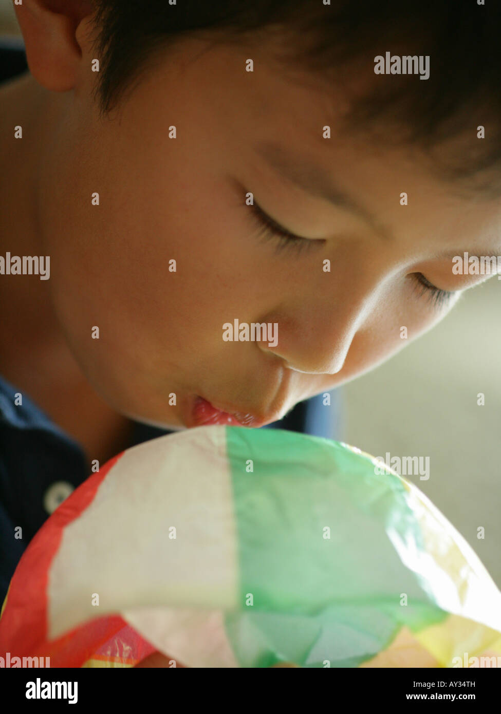 Boy blowing up balloon hi-res stock photography and images - Alamy