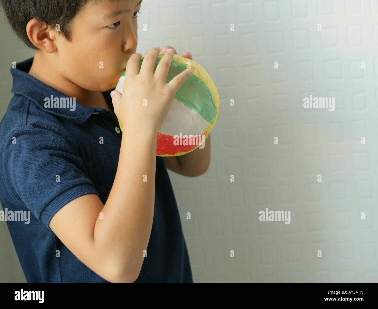 Child blowing up balloon hi-res stock photography and images - Alamy