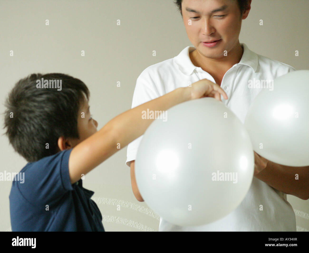 Man blowing up balloons hi-res stock photography and images - Alamy