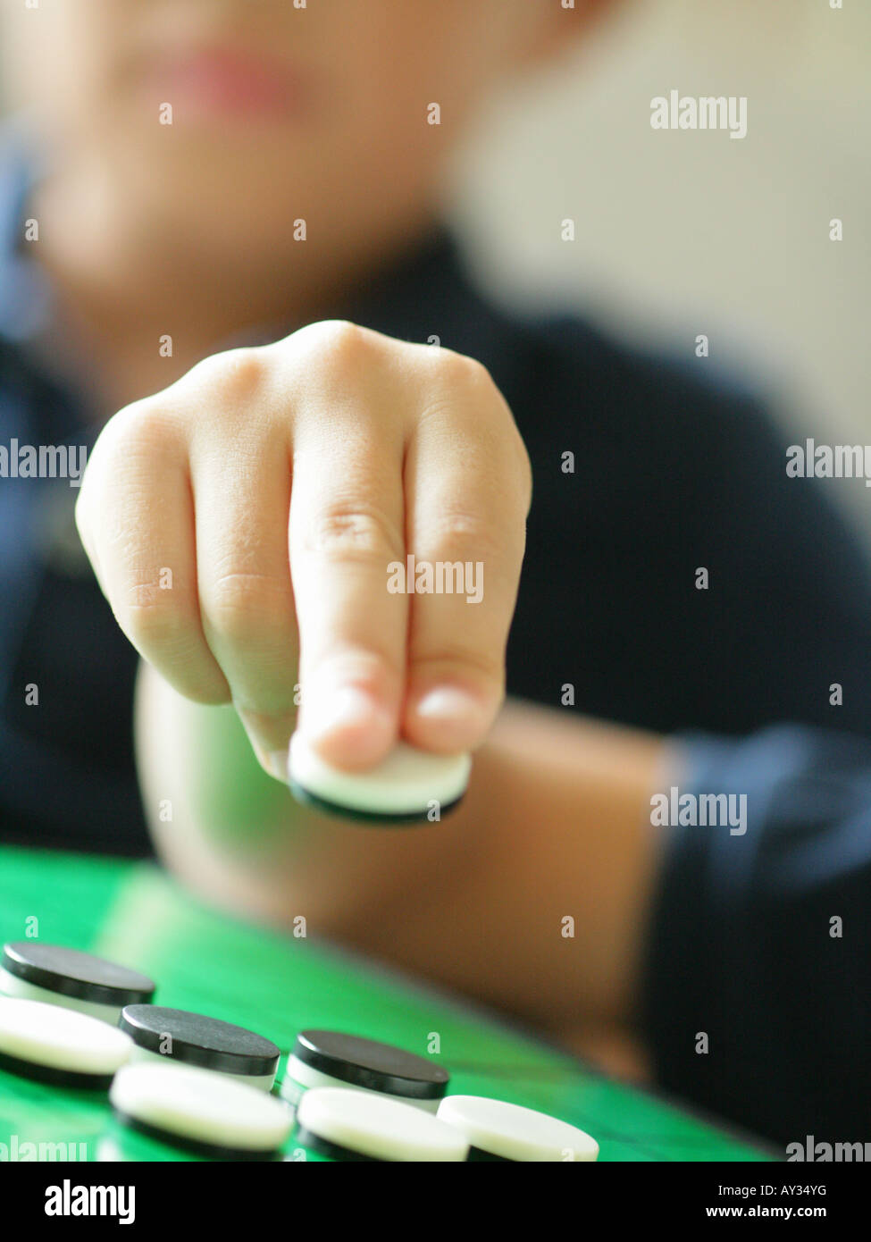 Close-up of a person's hand holding a board game piece Stock Photo - Alamy