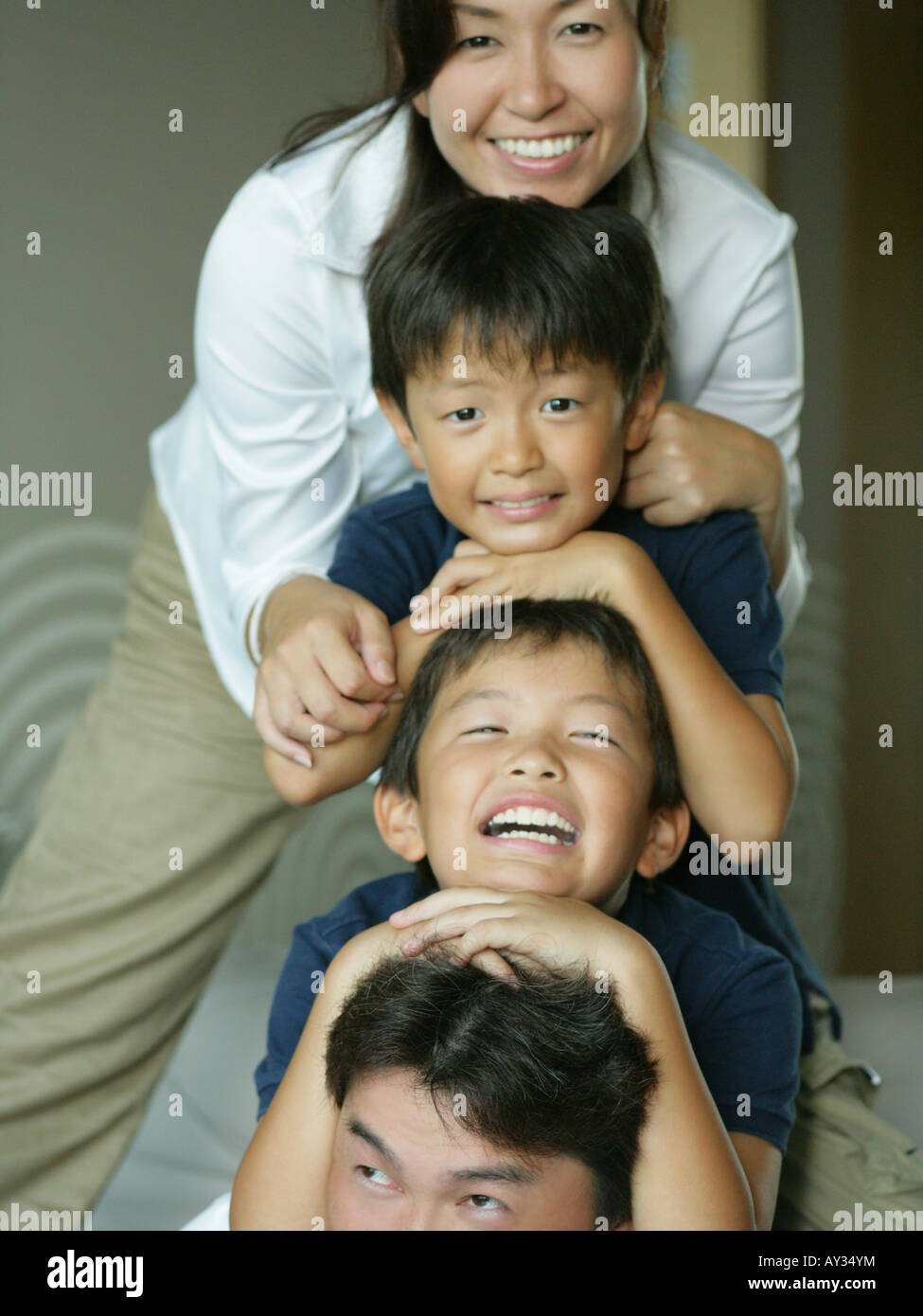 Mid adult couple and their two children in a row Stock Photo - Alamy