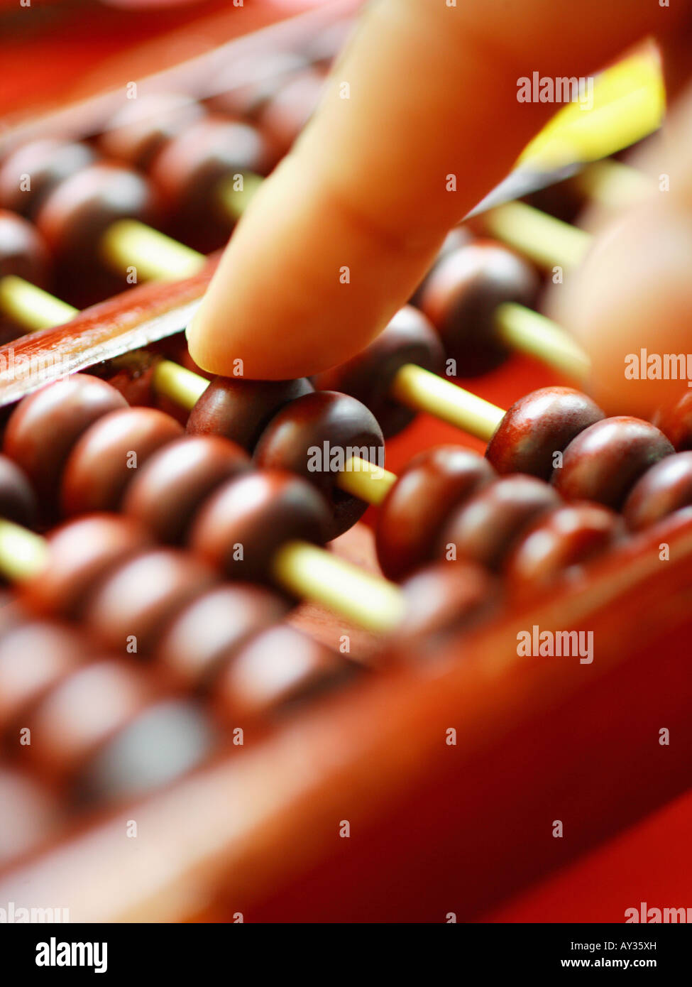 Close-up of a person's hand using a Chinese abacus Stock Photo - Alamy