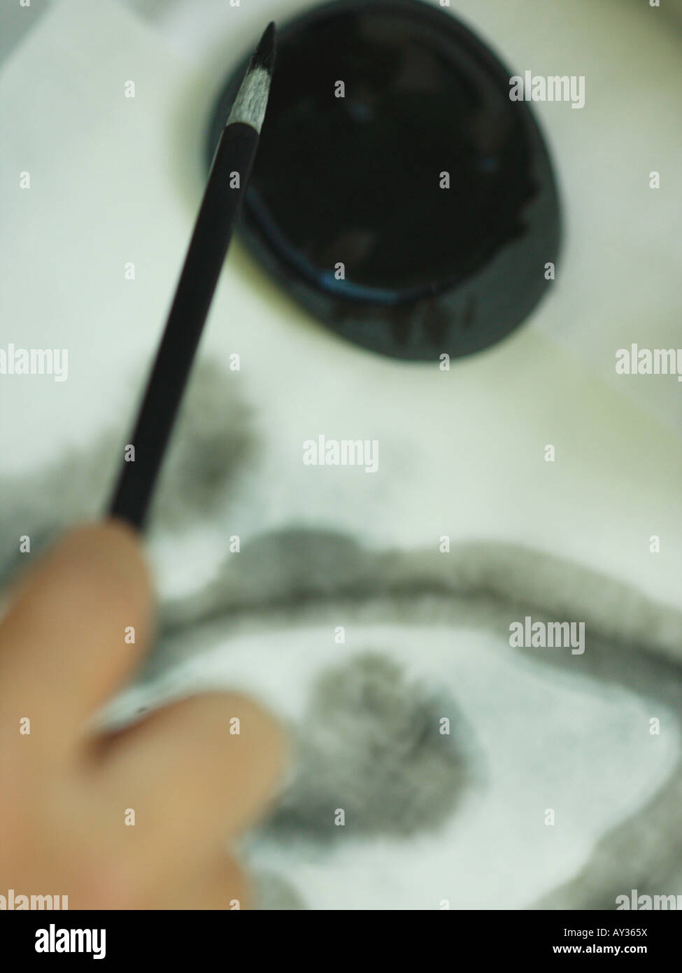 Close-up of a person's hand holding a ink brush Stock Photo - Alamy