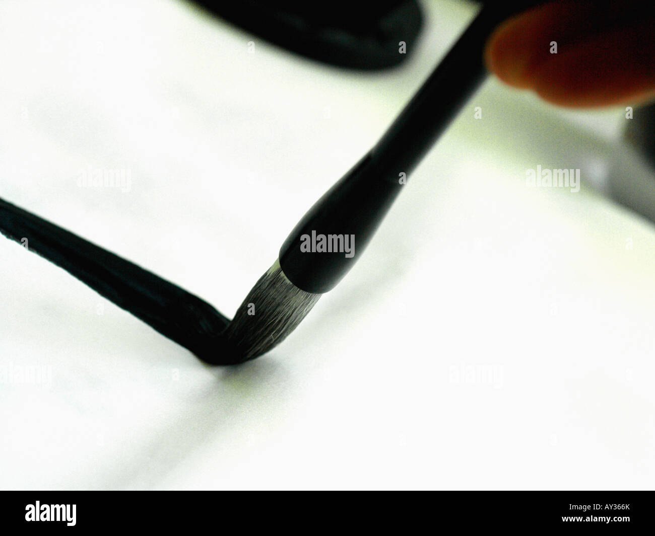 Close-up of a ink brush drawing a single line Stock Photo - Alamy