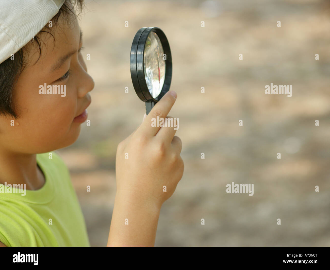 Side profile of a boy looking through a magnifying glass Stock Photo ...