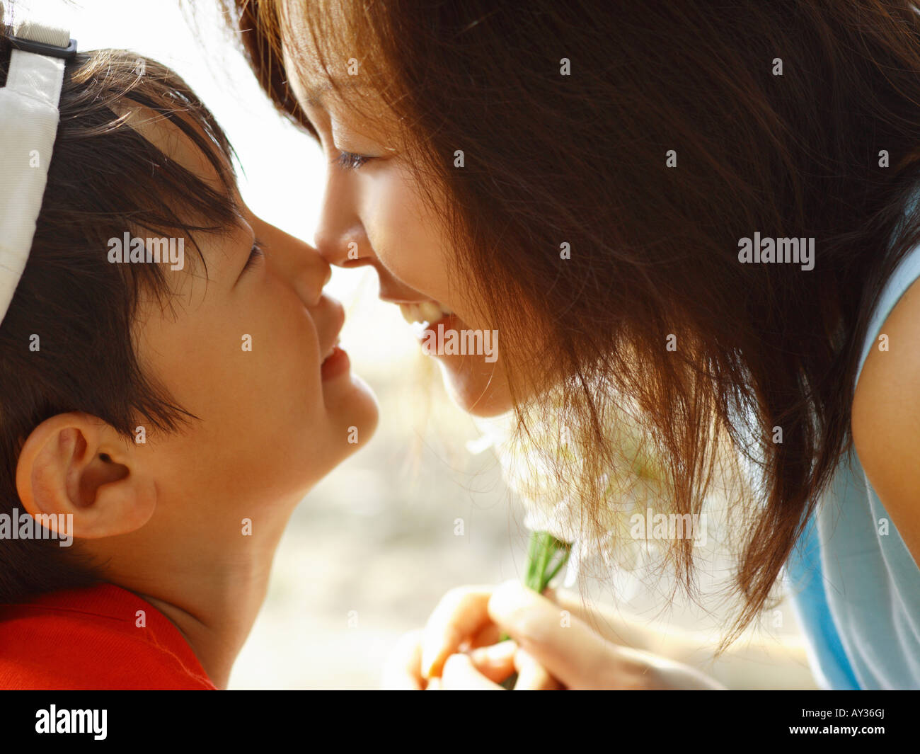 Close-up of a mother face to face with her son and smiling Stock Photo ...