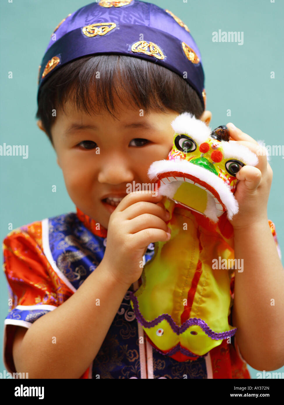 Portrait of a boy holding a toy Stock Photo - Alamy