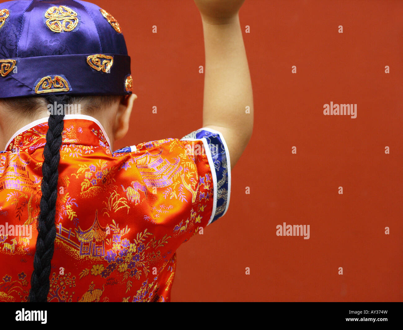 Rear view of a boy raising a hand Stock Photo - Alamy