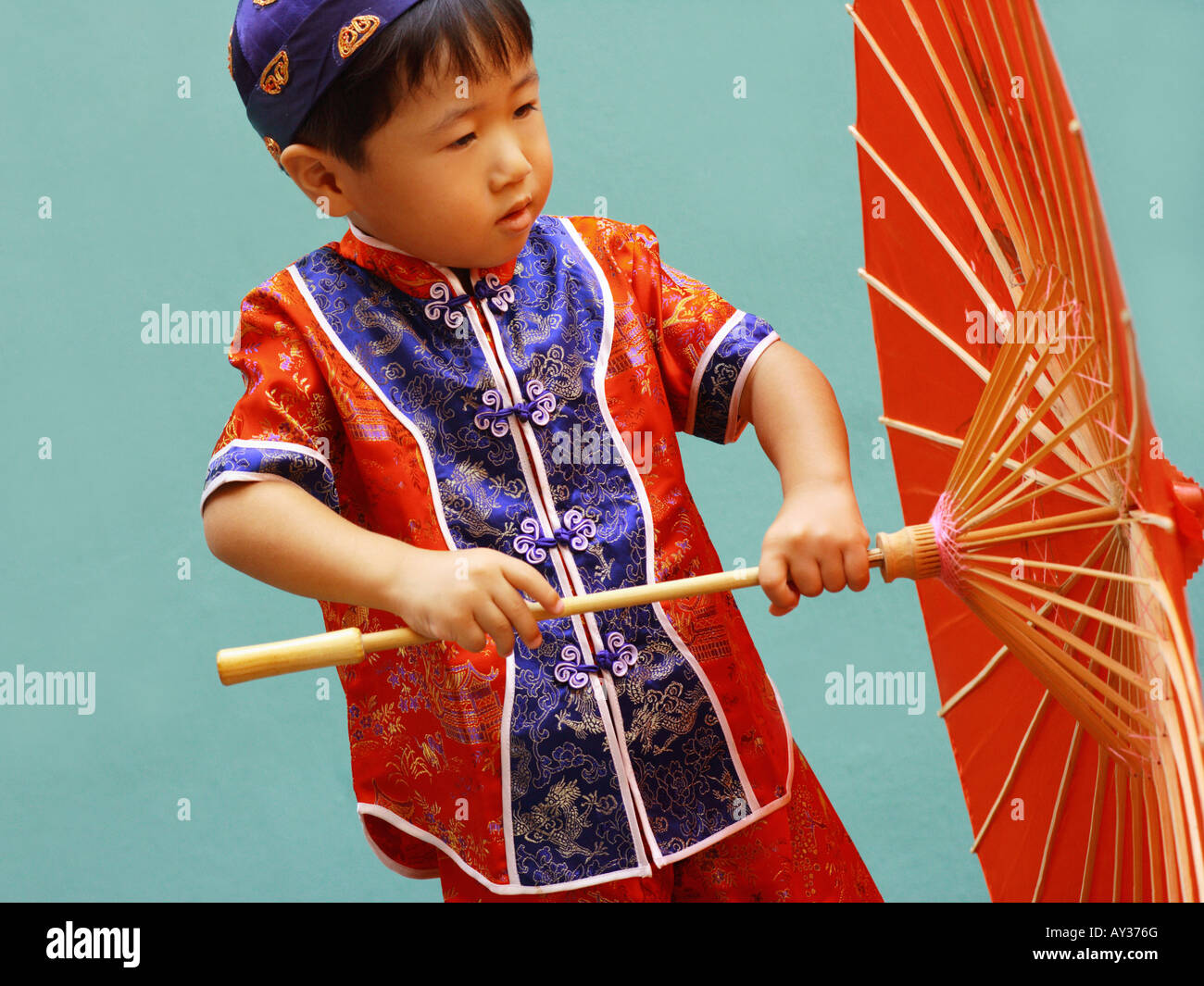 Boy holding parasol hi-res stock photography and images - Alamy