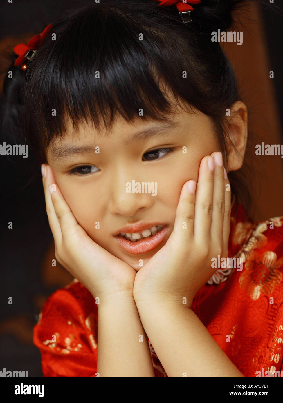 Close-up of a girl with her hand on her cheek Stock Photo - Alamy