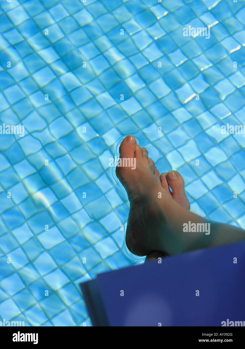 High angle view of a person's legs at the poolside Stock Photo - Alamy