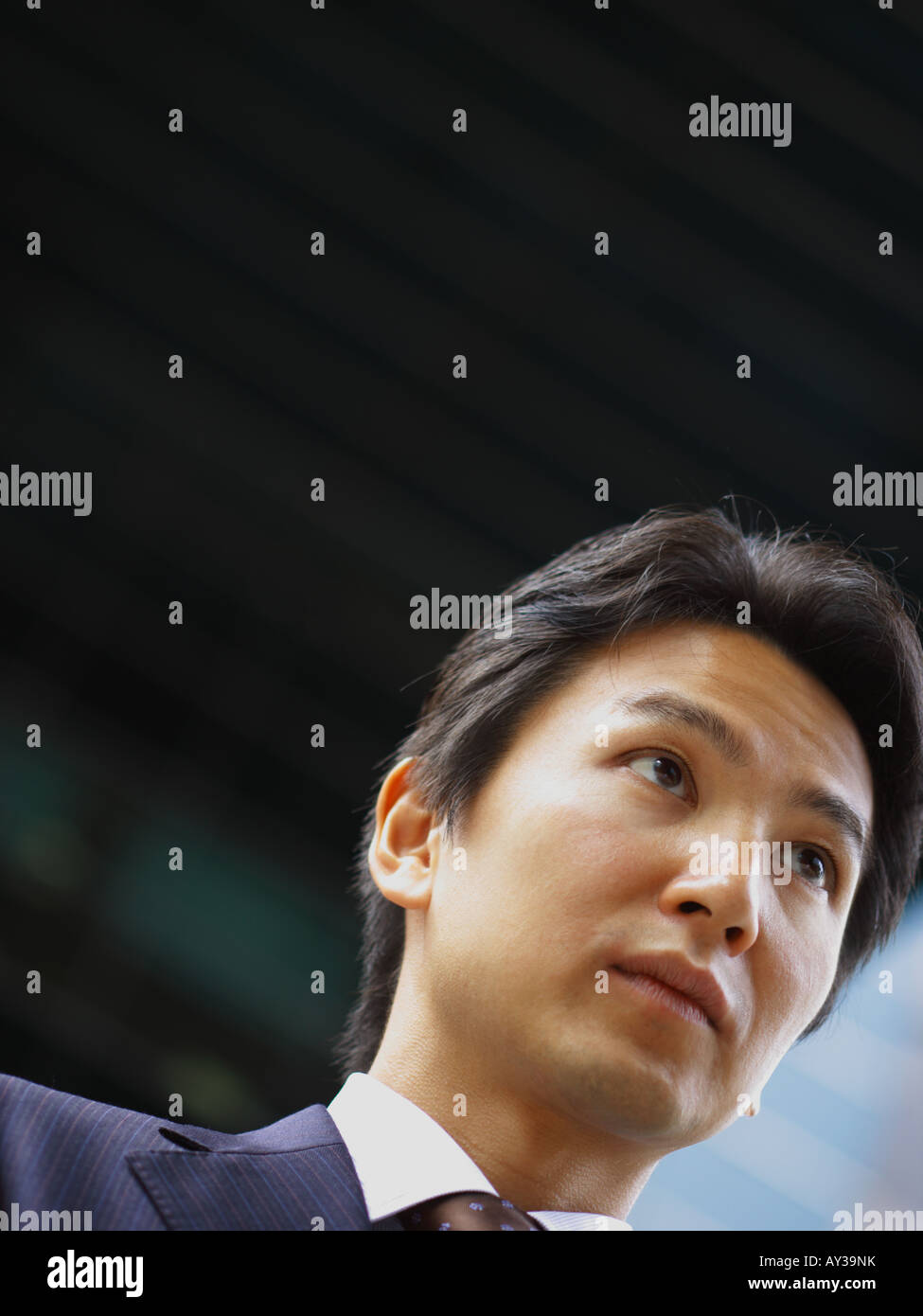 Low angle view of a businessman looking away Stock Photo - Alamy