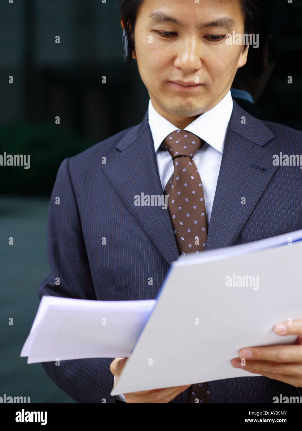 Standing looking down reading communication document hi-res stock ...