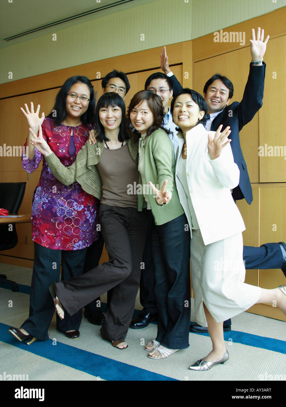 Portrait of a group of business executives cheering in an office Stock ...