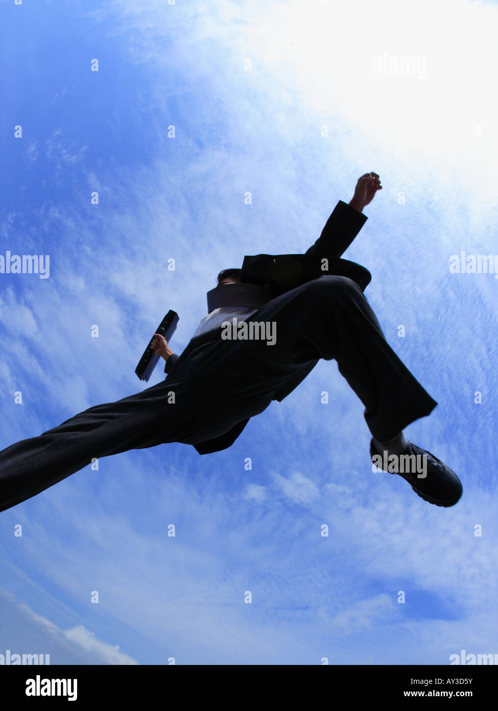 Low angle view of a businessman jumping in mid-air Stock Photo - Alamy