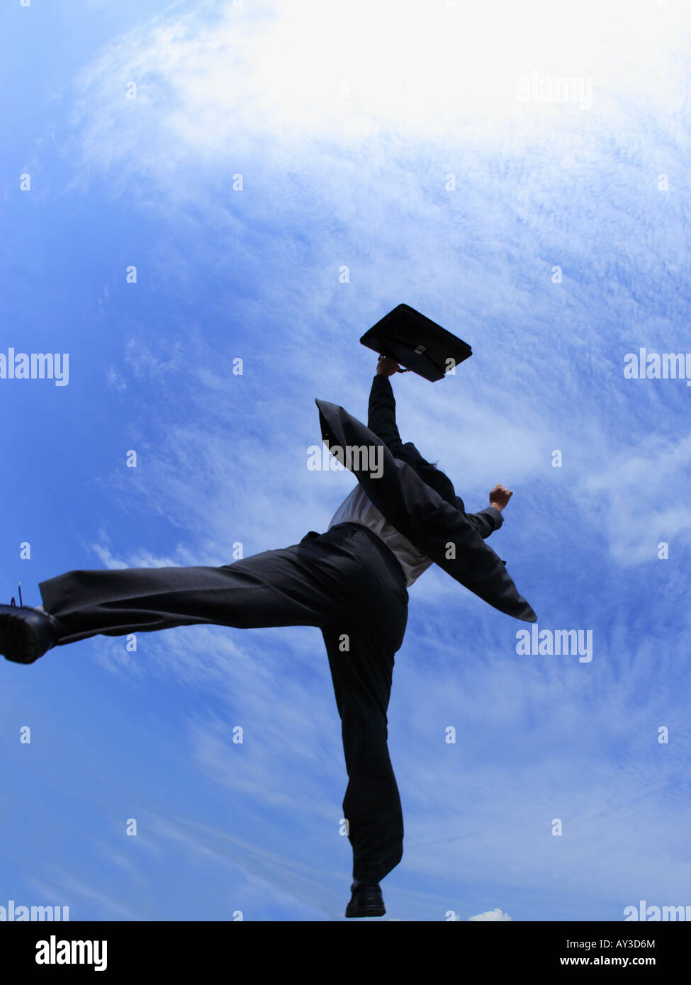Low angle view of a businessman jumping in mid-air Stock Photo - Alamy