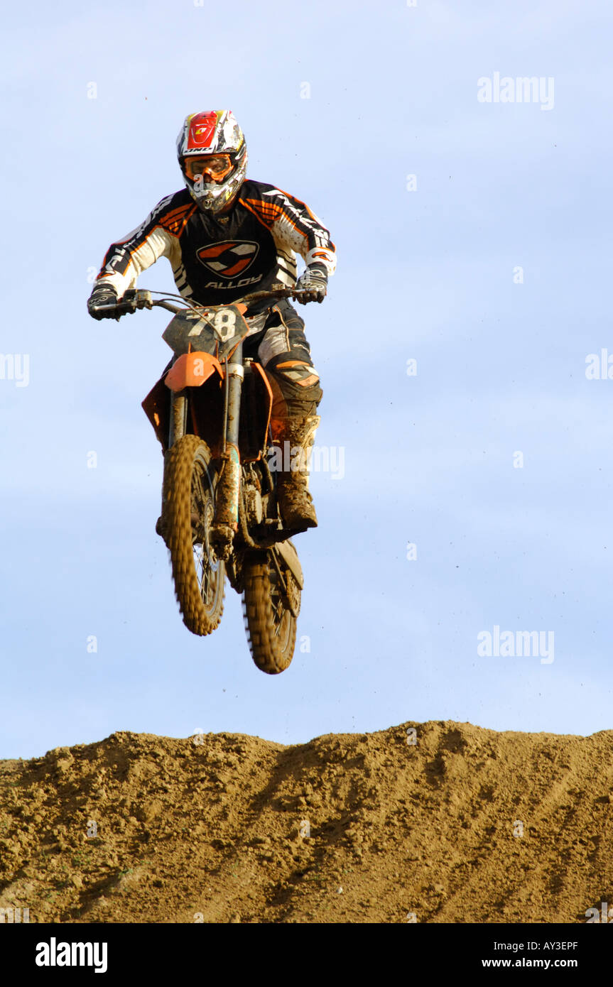 a guy rider on a motocross bile motorcycle jumping and racing big air ...