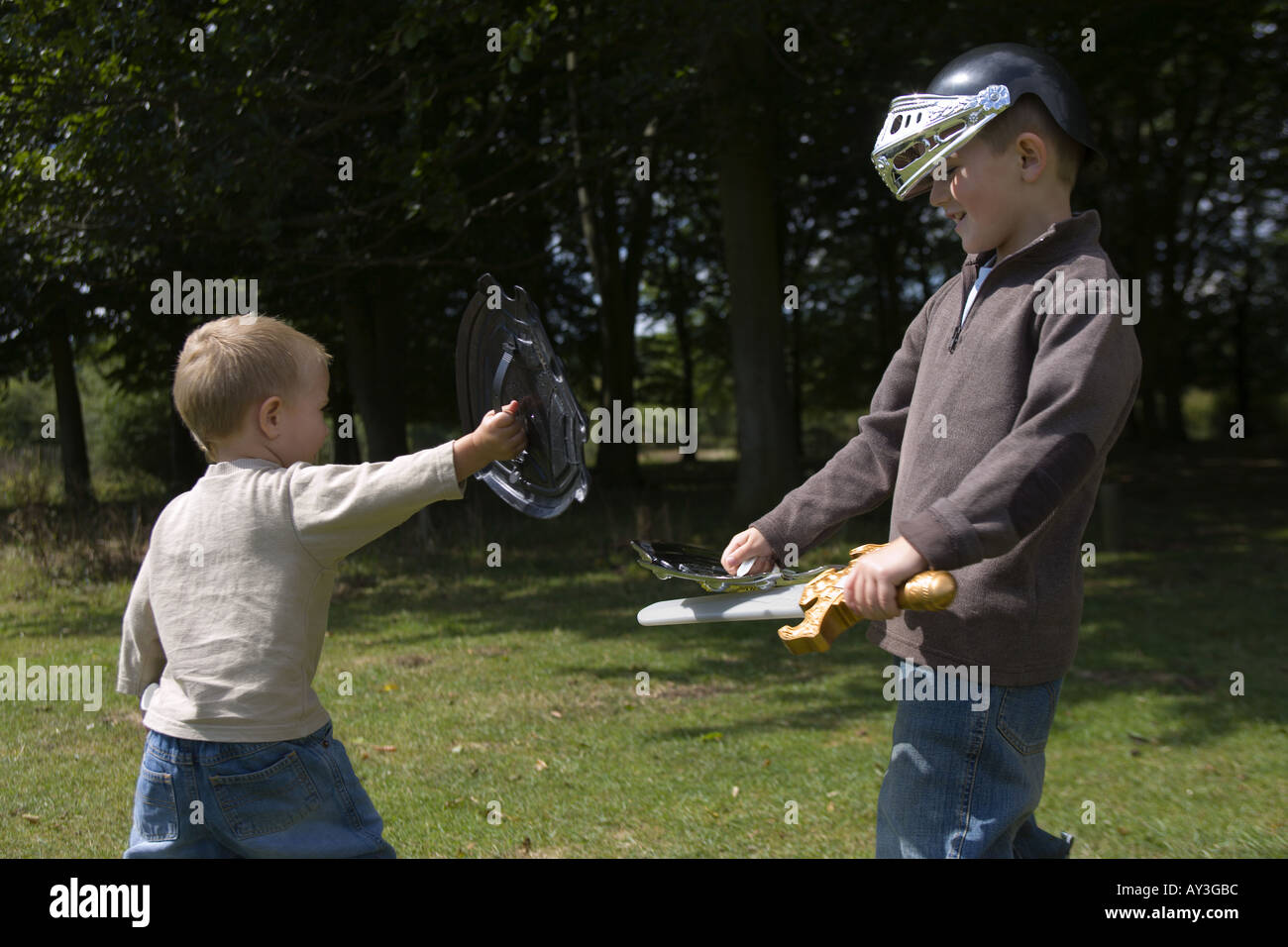 Two boys sword fighting Stock Photo - Alamy