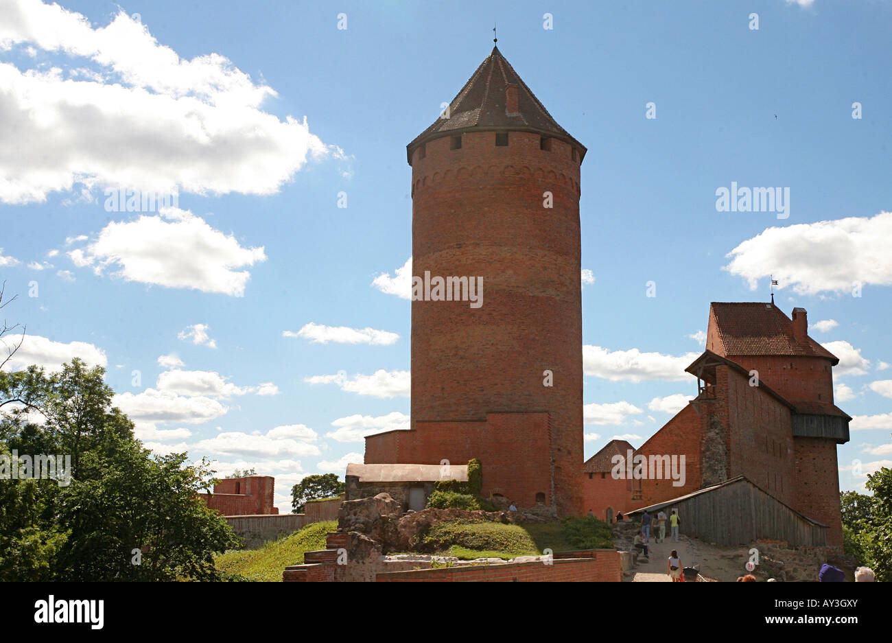 Castle tower round shape red brick wall with attached buildings and ...