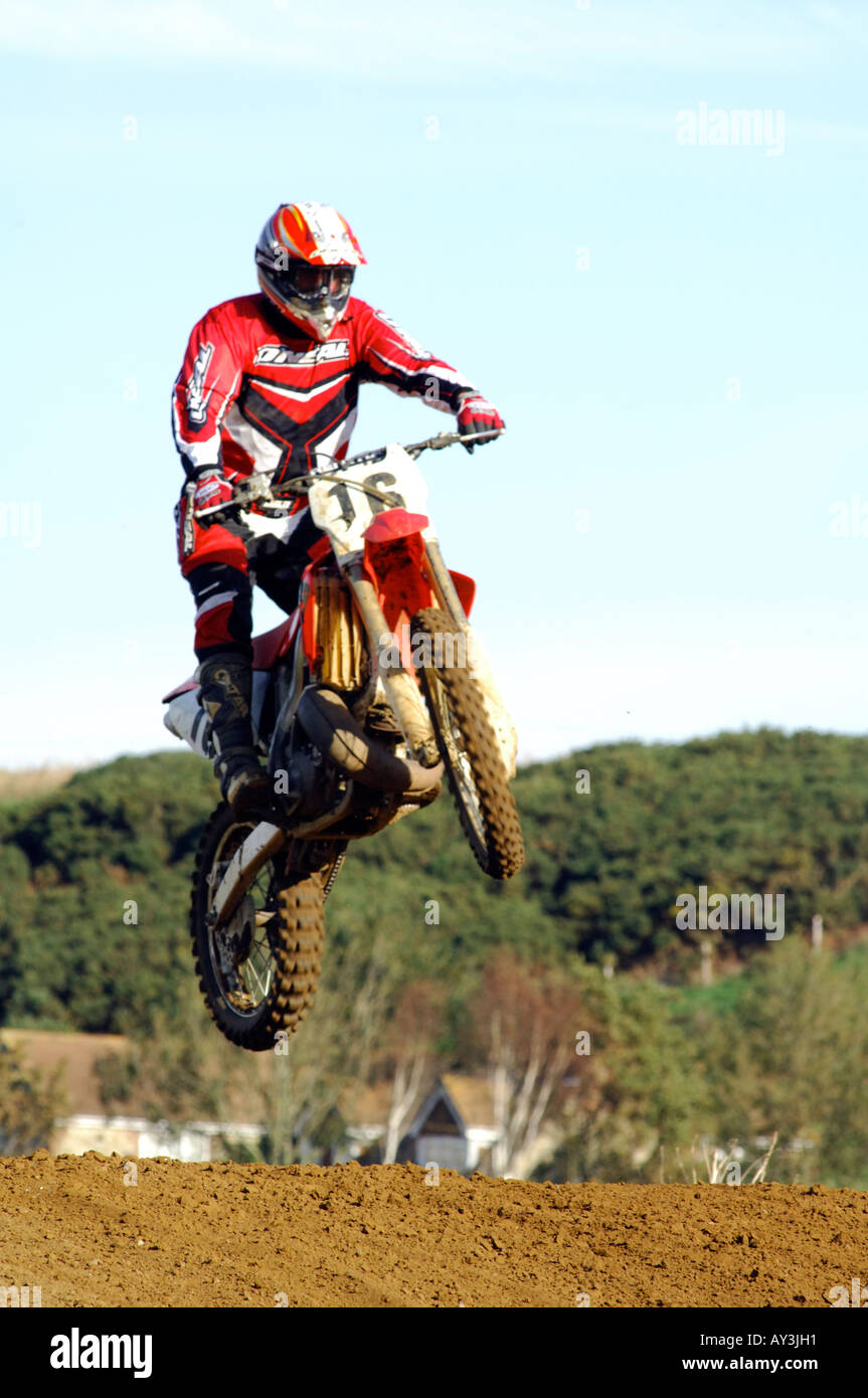 a guy rider on a motocross bile motorcycle jumping and racing big air ...