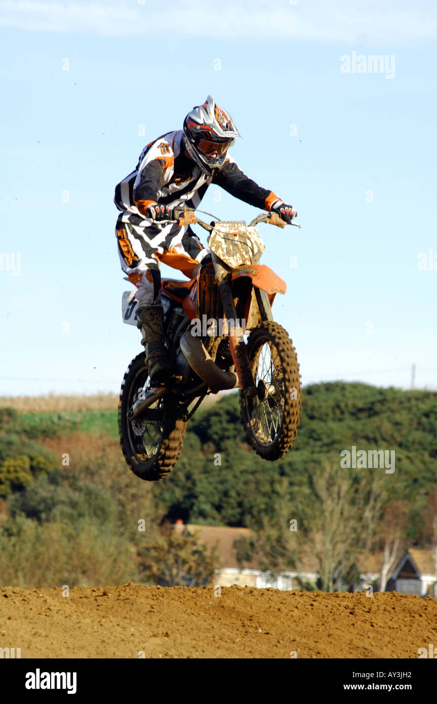 a guy rider on a motocross bile motorcycle jumping and racing big air ...