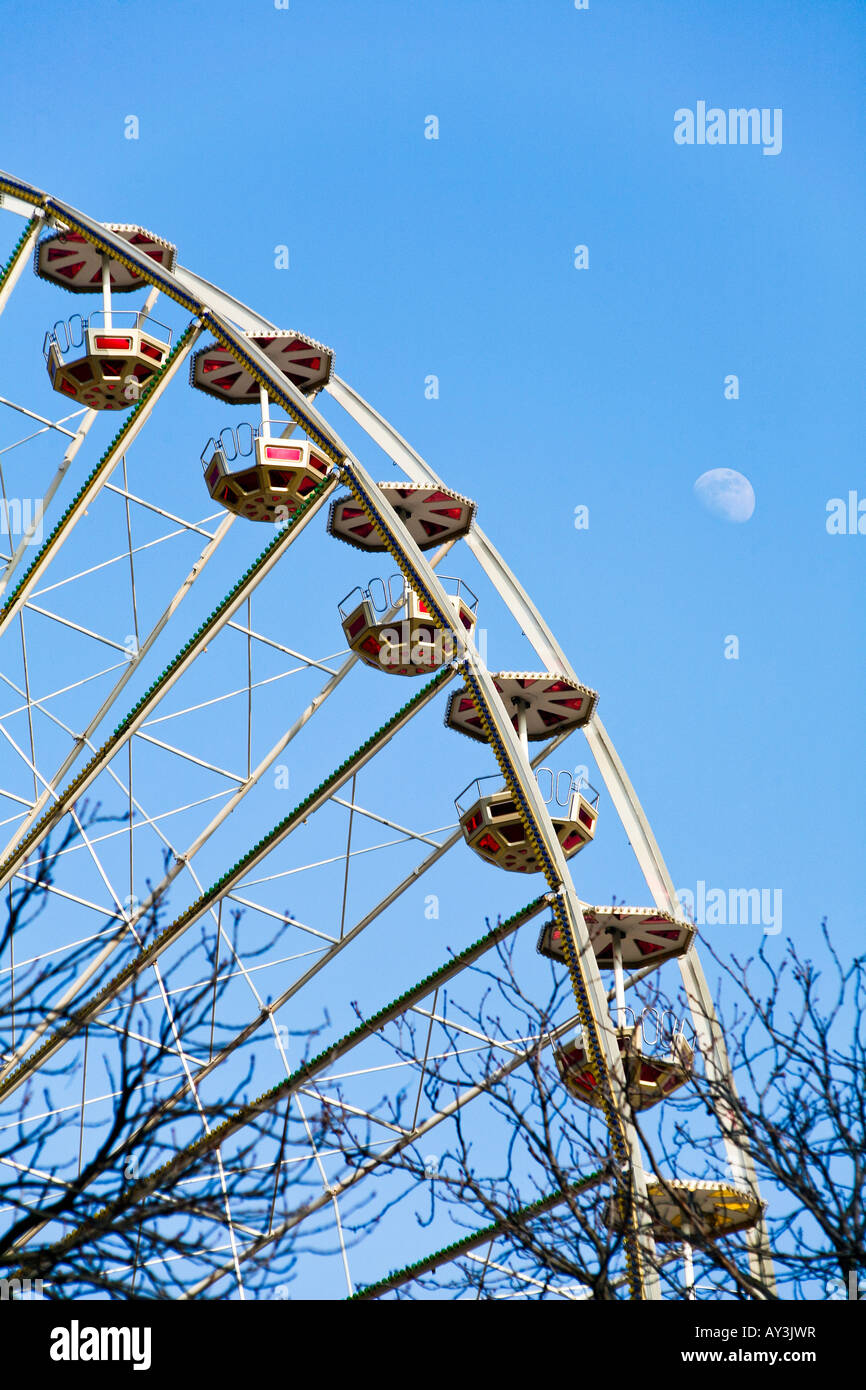 A ferris wheel with a blue sky and the moon in the background Stock ...