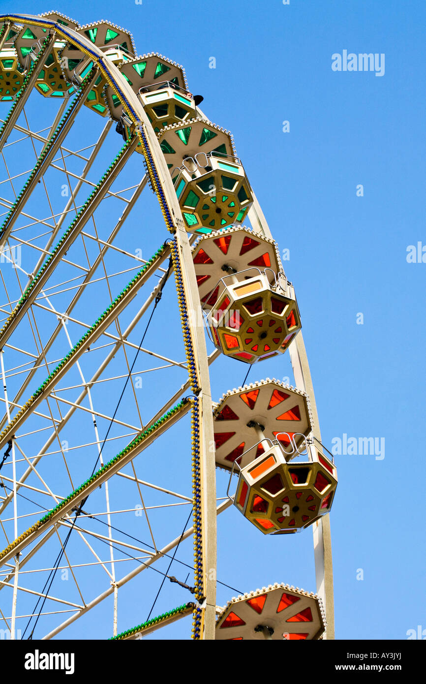 A ferris wheel with a blue sky and the moon in the background Stock ...