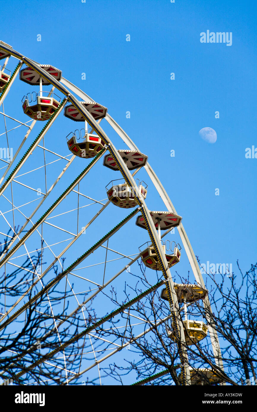 A ferris wheel with a blue sky and the moon in the background Stock ...