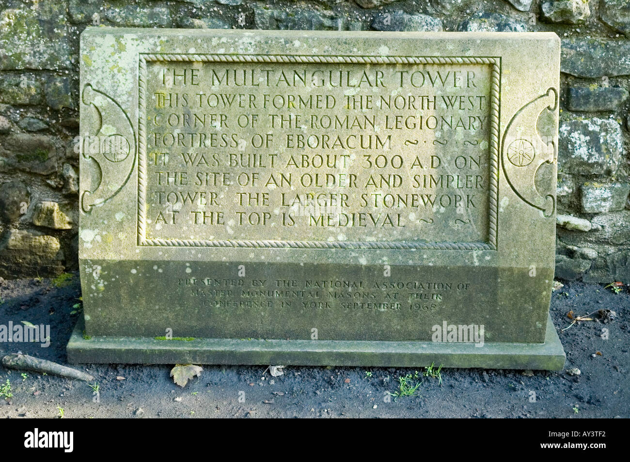 Stone plaque in front a tower which formed part of the roman fortress ...