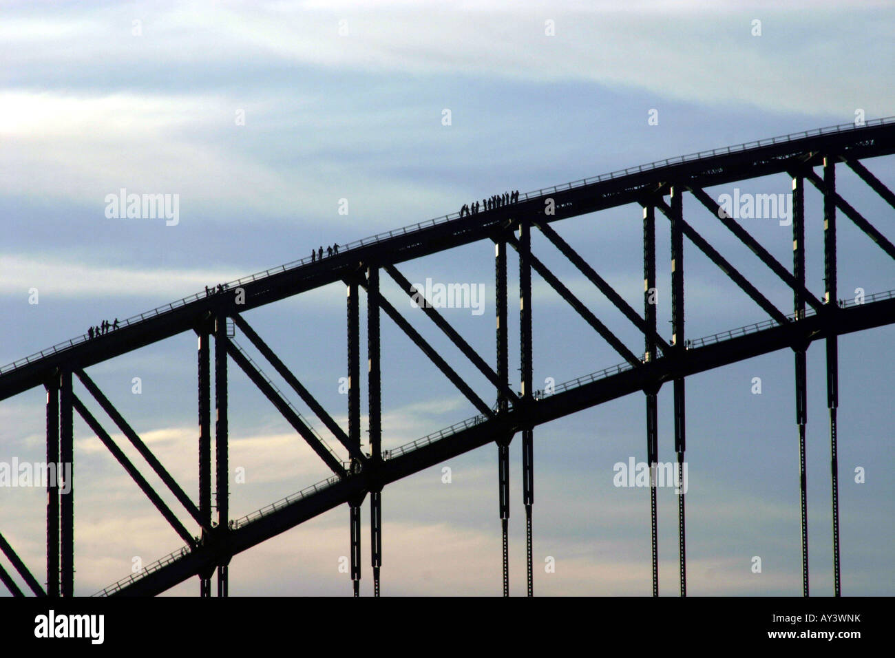 Sydney Opera House and tourists walking over the Sydney Harbour Bridge ...