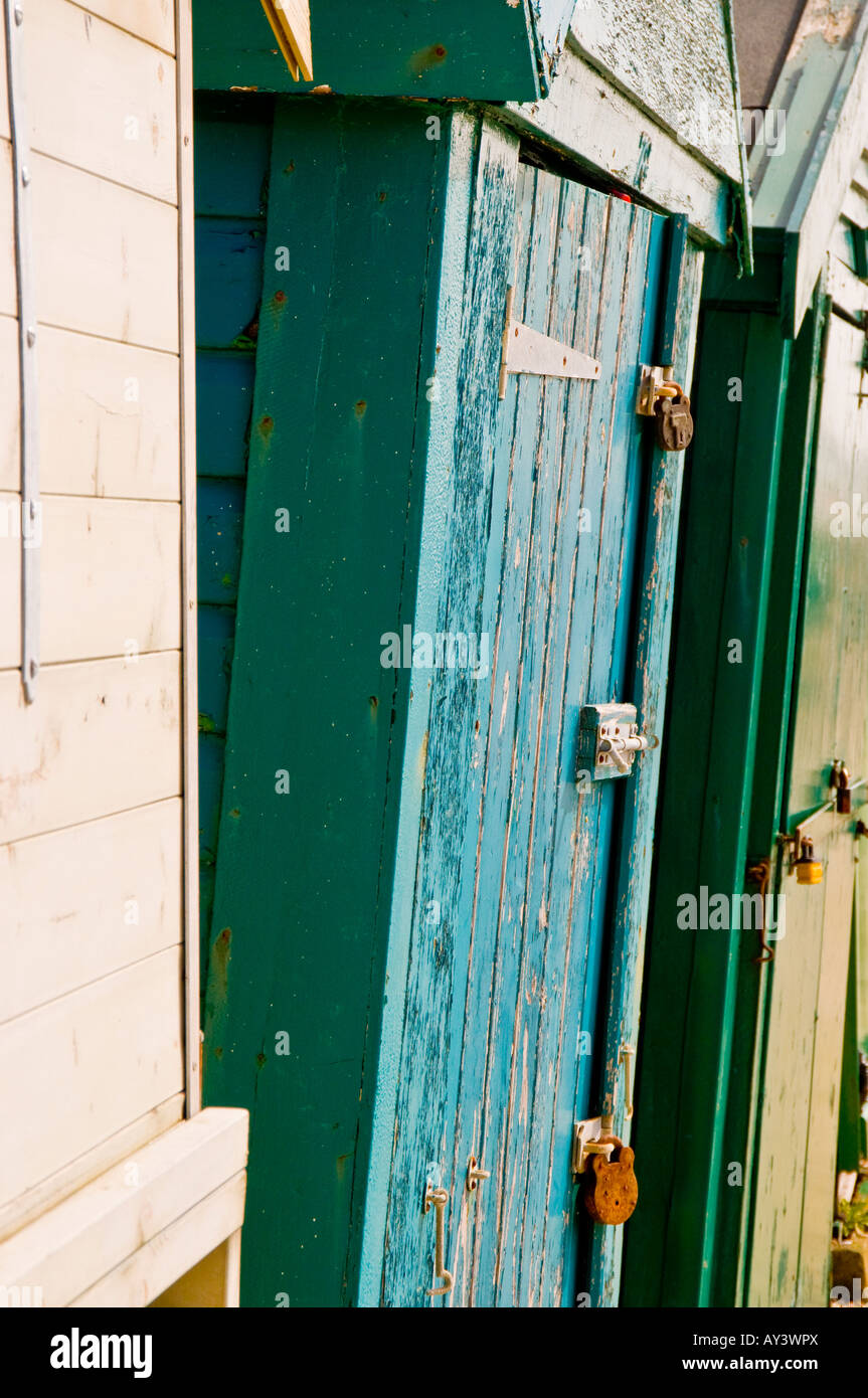 green beach hut door leaning forward Stock Photo - Alamy