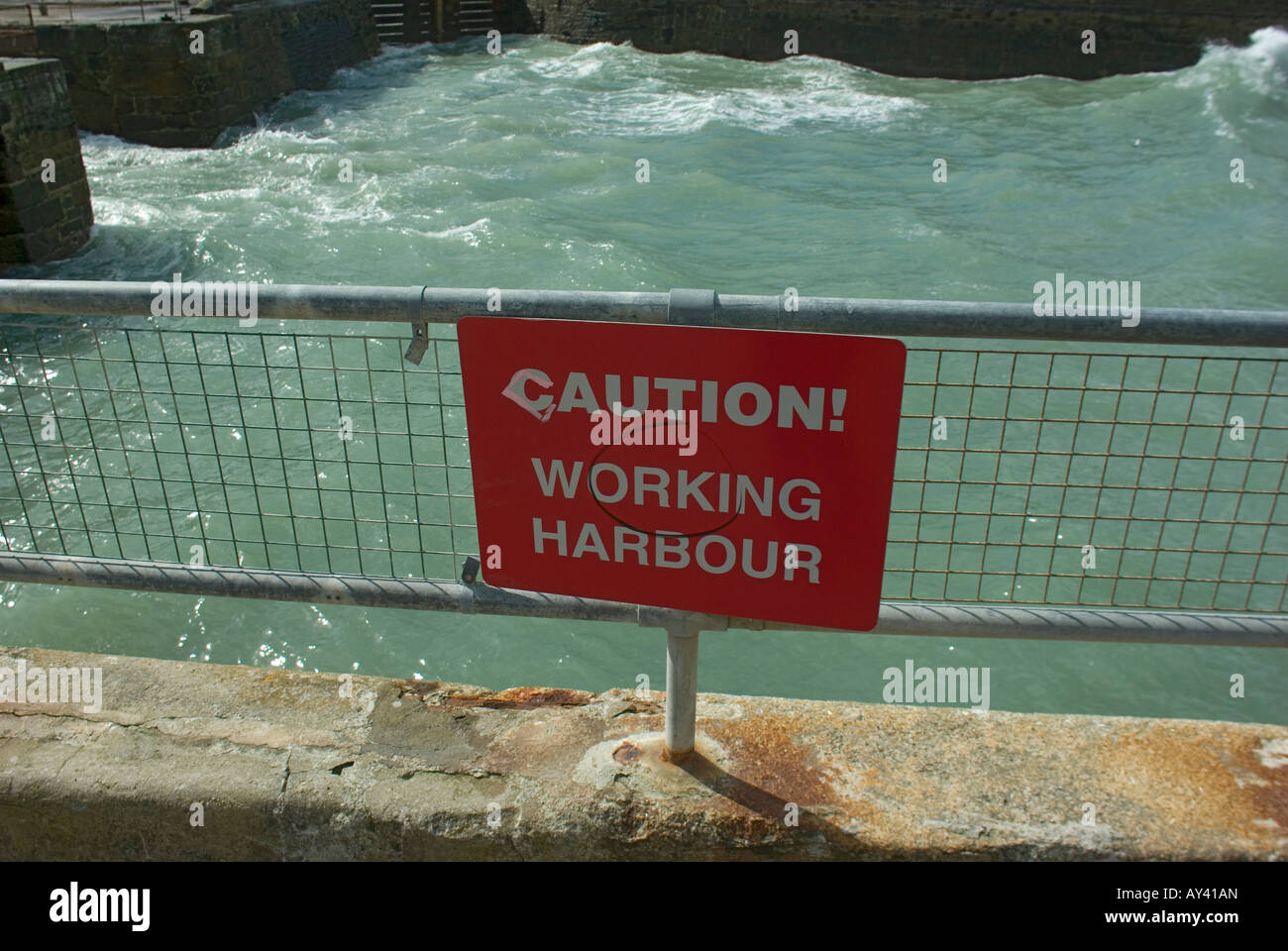 Caution Working Harbour sign with tide Portreath Cornwall UK Stock ...