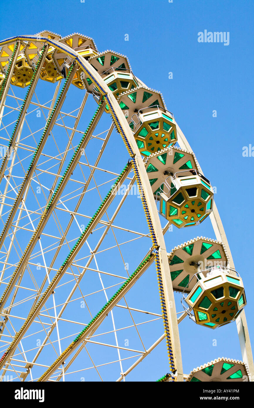A ferris wheel with a blue sky and the moon in the background Stock ...