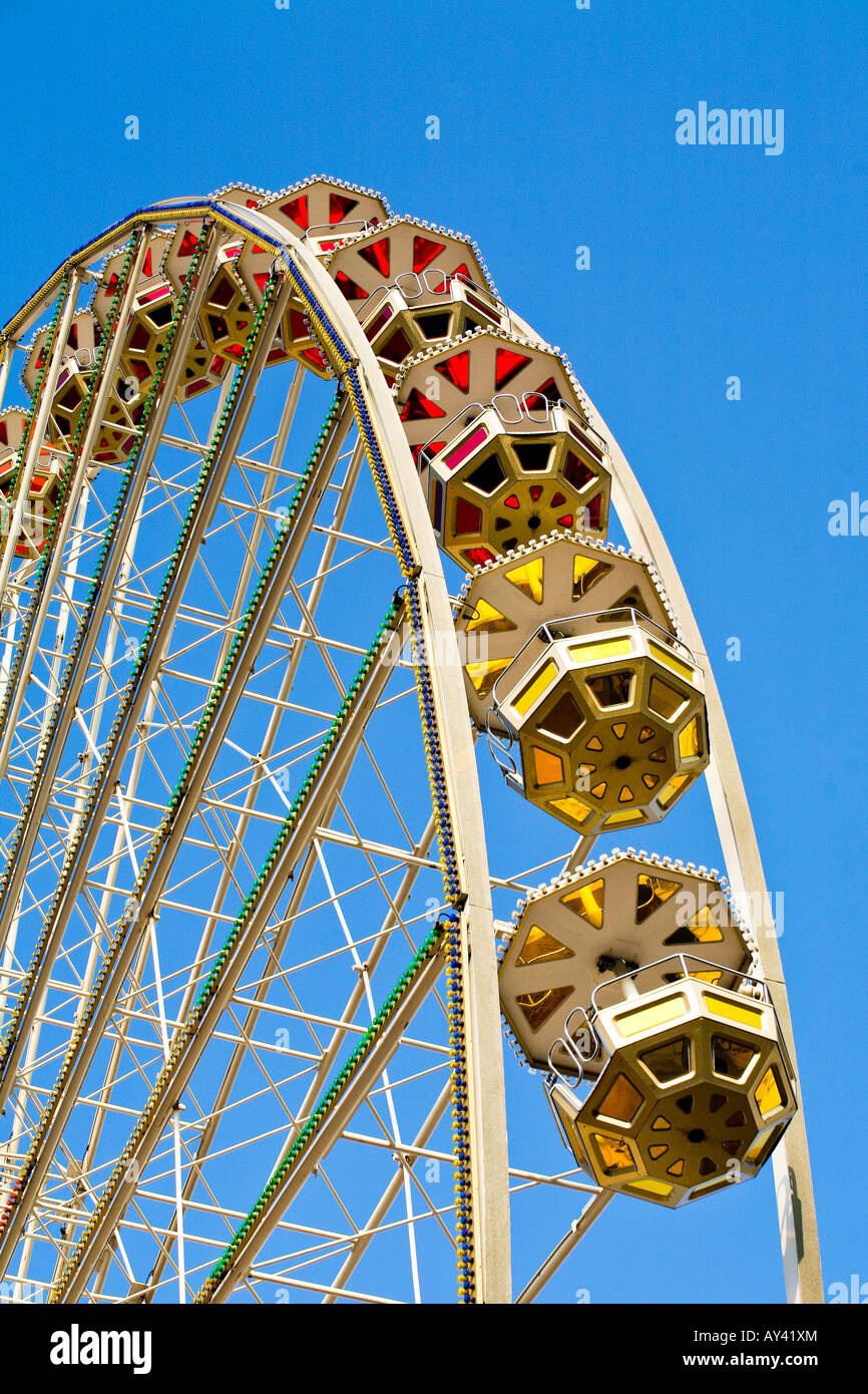 A ferris wheel with a blue sky and the moon in the background Stock ...