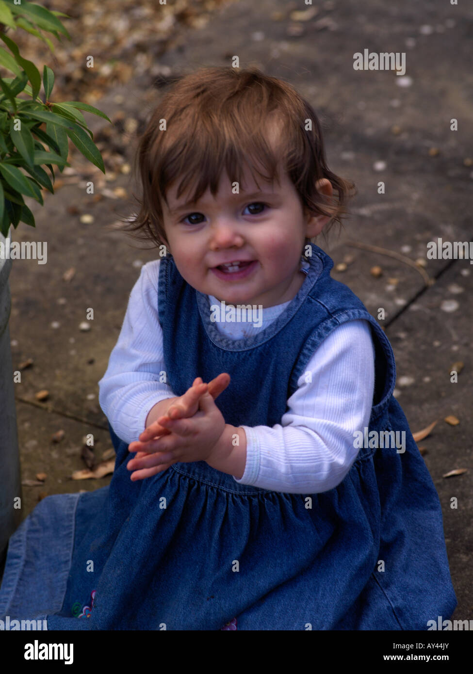 Fifteen Month Baby Girl Clapping in the garden Stock Photo - Alamy