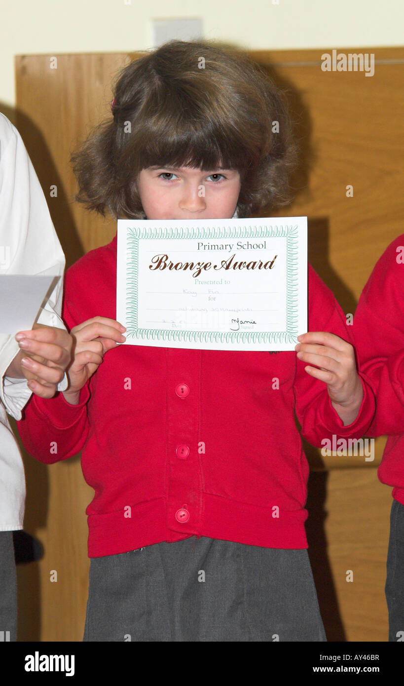 Girl Holding a Certificate in a School assembly Stock Photo - Alamy