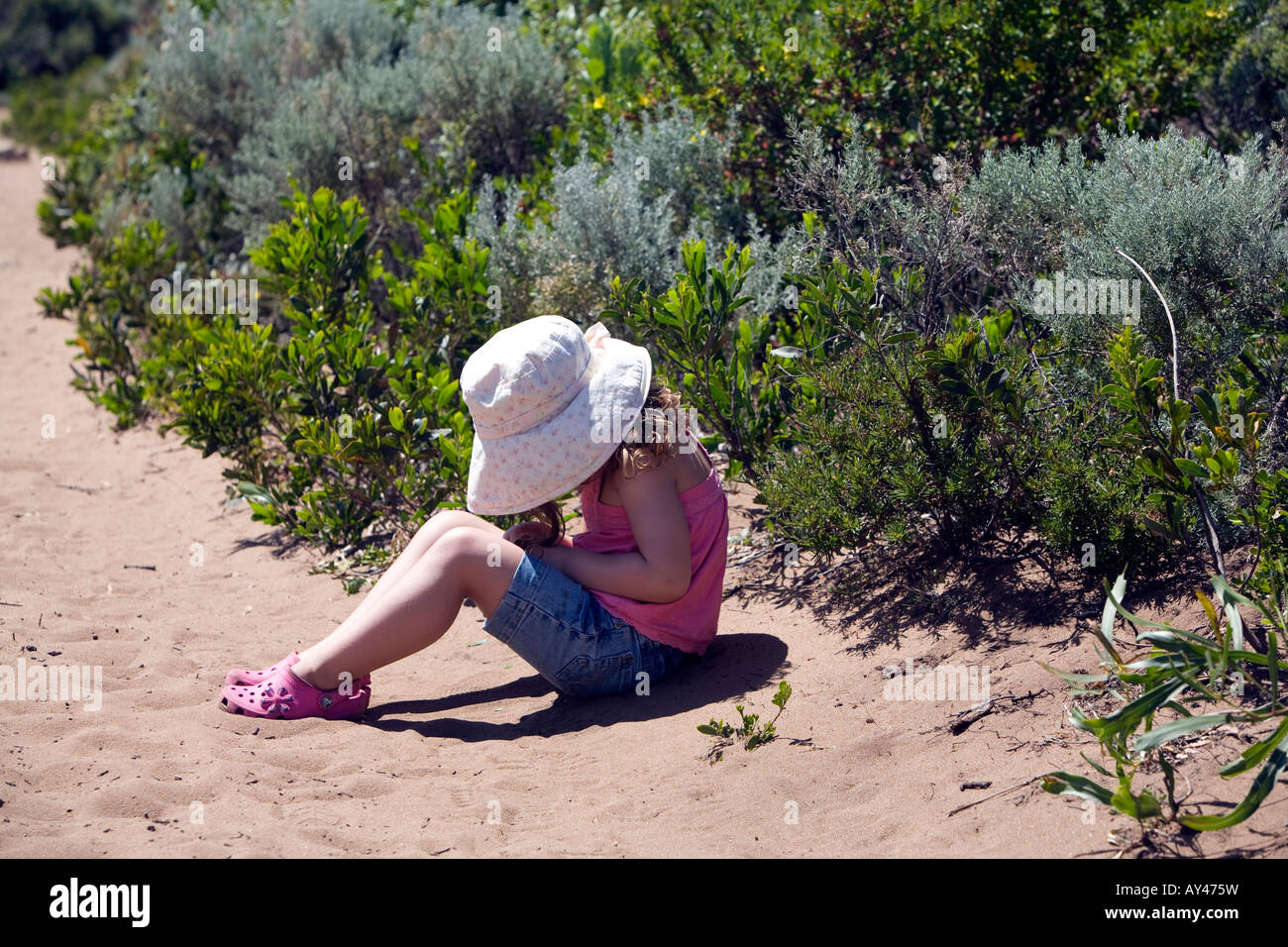 Child sitting down for a rest Stock Photo - Alamy