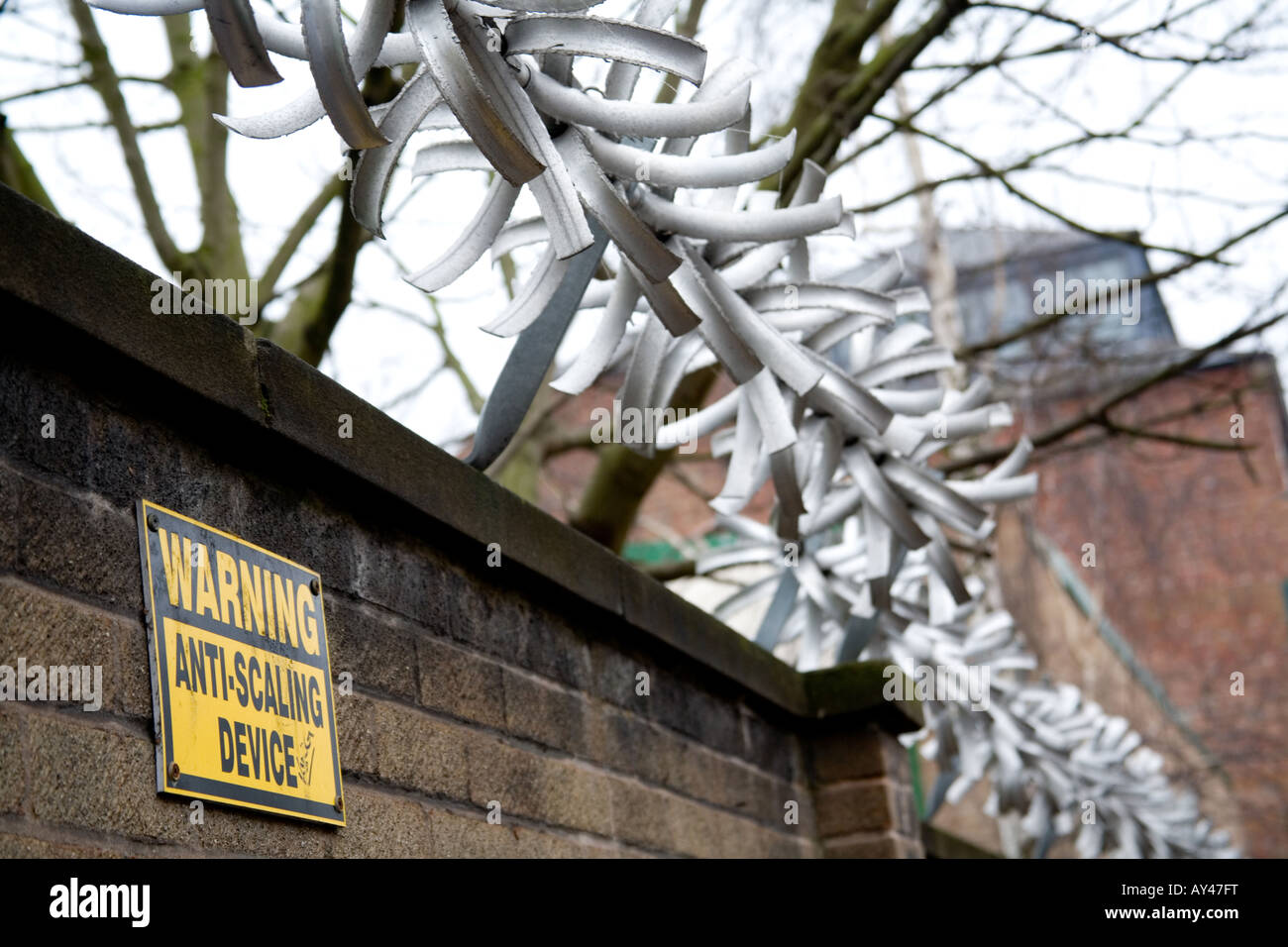 A warning sign about an anti-scaling device on a wall Stock Photo - Alamy