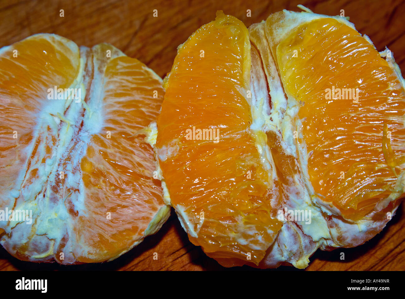 Peeled navel orange in sections Stock Photo - Alamy