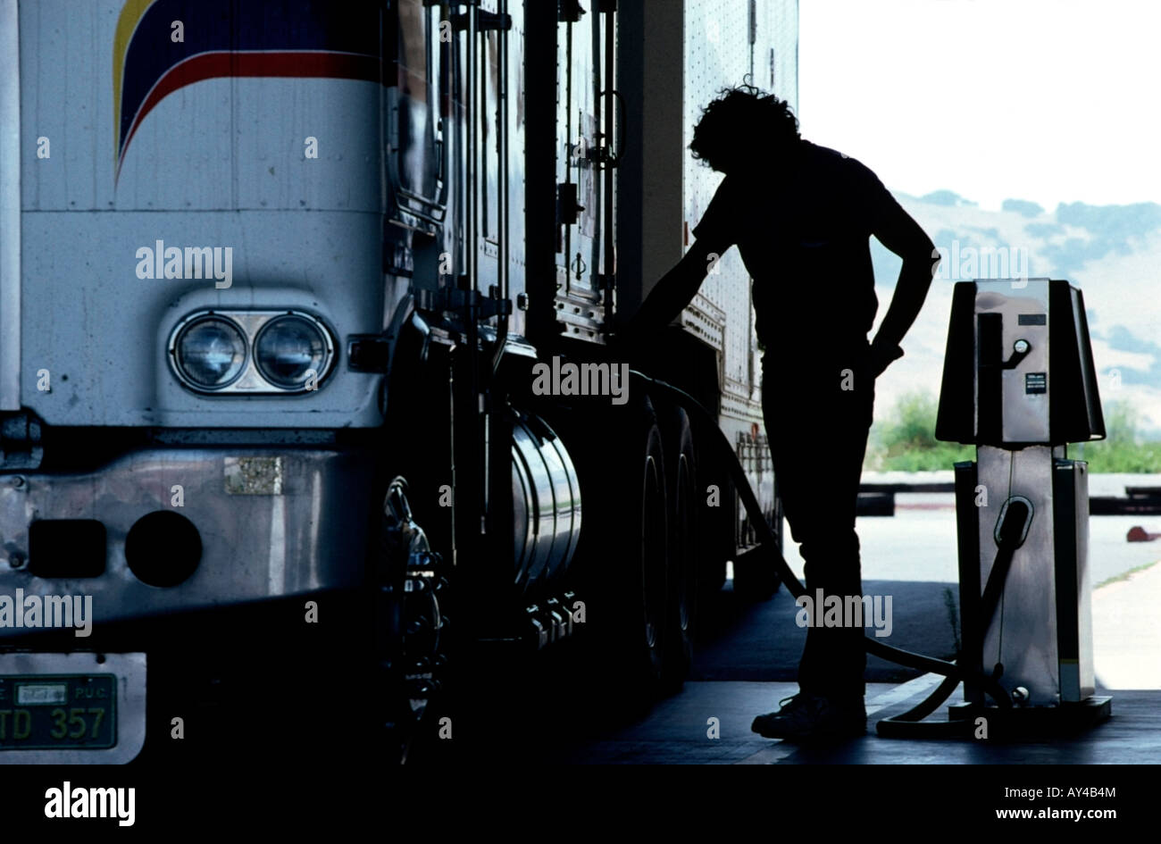 Independent Truck Driver fills his Diesel Simi Truck with fuel at a ...