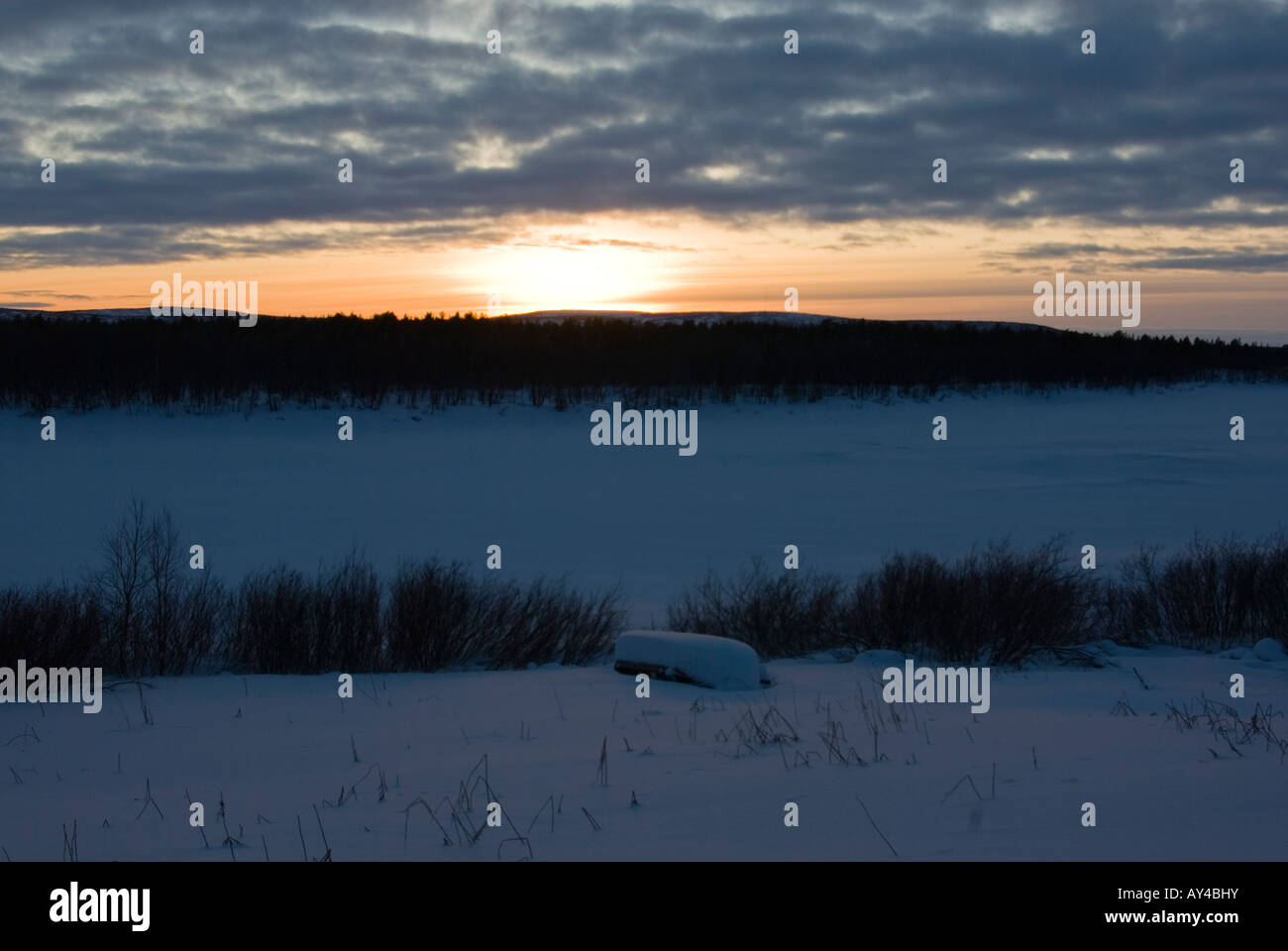 A river boat buried in snow at the shore of tornio river in finnish ...